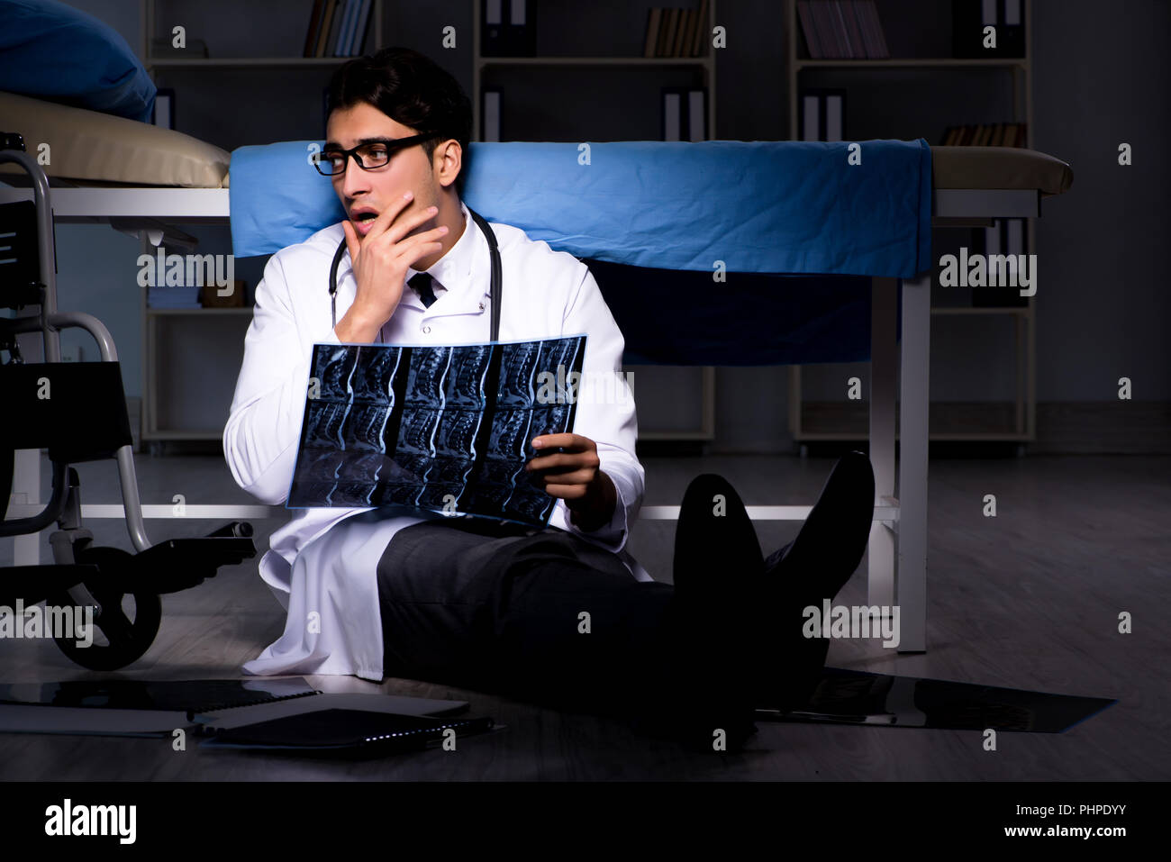 Doctor working night shift in hospital after long hours Stock Photo - Alamy