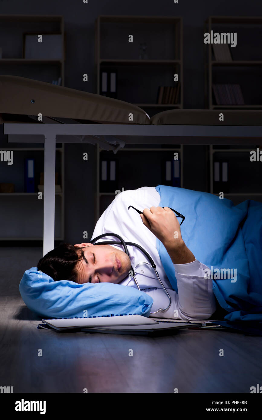 Doctor working night shift in hospital after long hours Stock Photo - Alamy