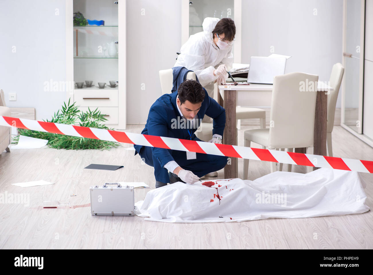 Forensics investigator at the scene of office crime Stock Photo - Alamy