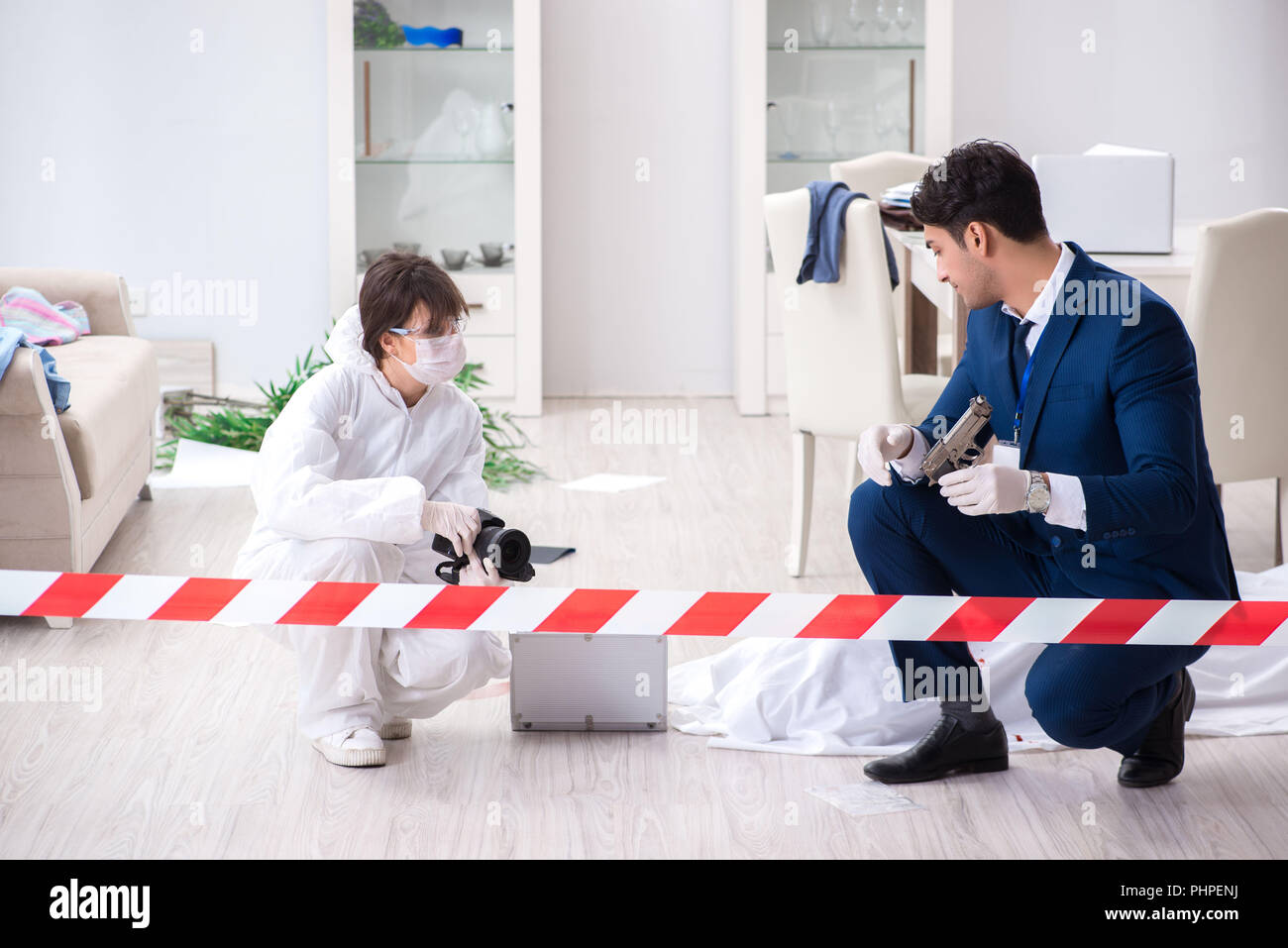 Forensics investigator at the scene of office crime Stock Photo - Alamy