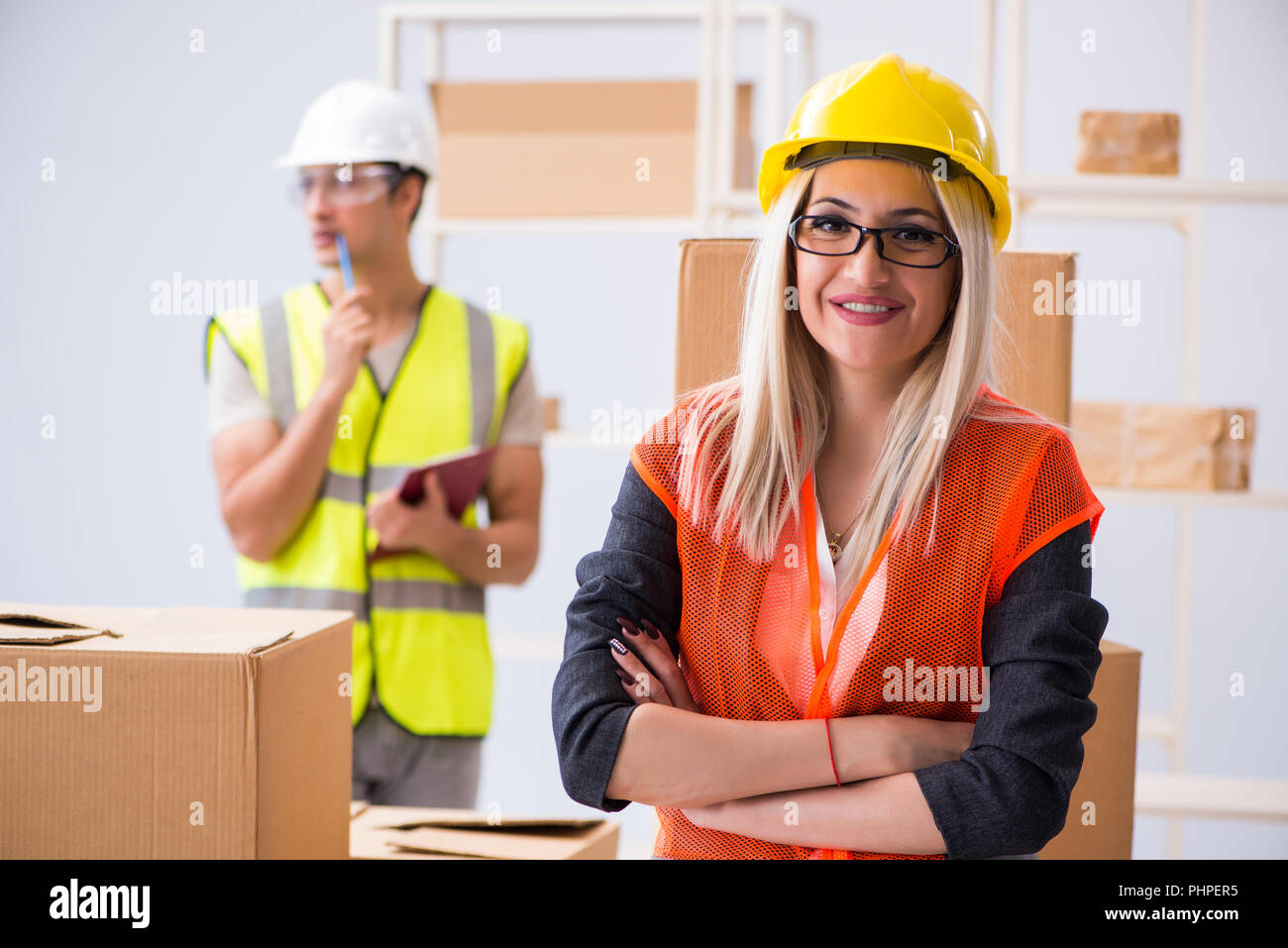 Delivery contractor delivering boxes to office Stock Photo - Alamy
