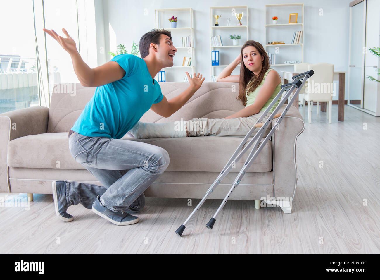 Husband man supporting injured wife Stock Photo - Alamy