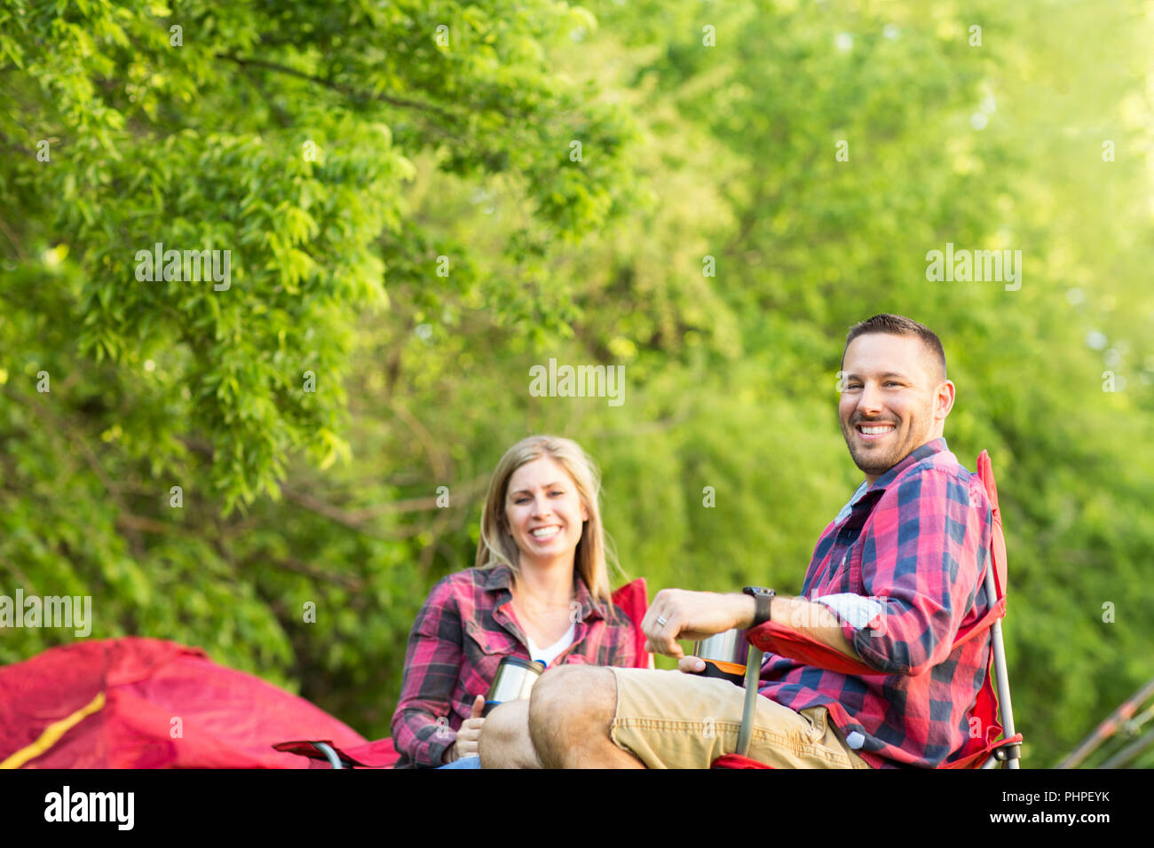Couple talking and laughing on a camping trip Stock Photo - Alamy