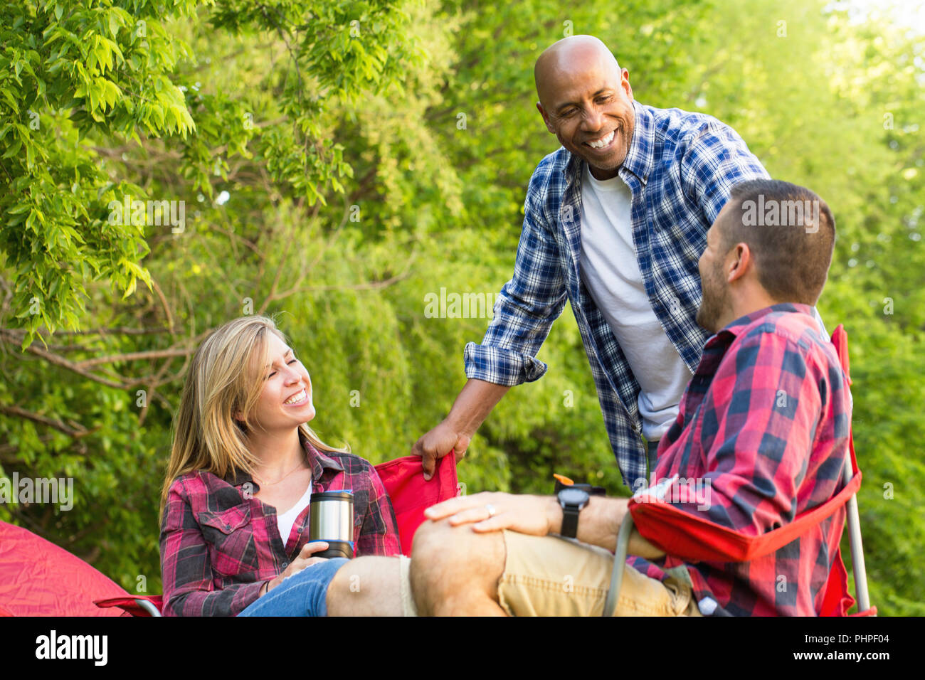 Group of friends laughing and talking Stock Photo - Alamy