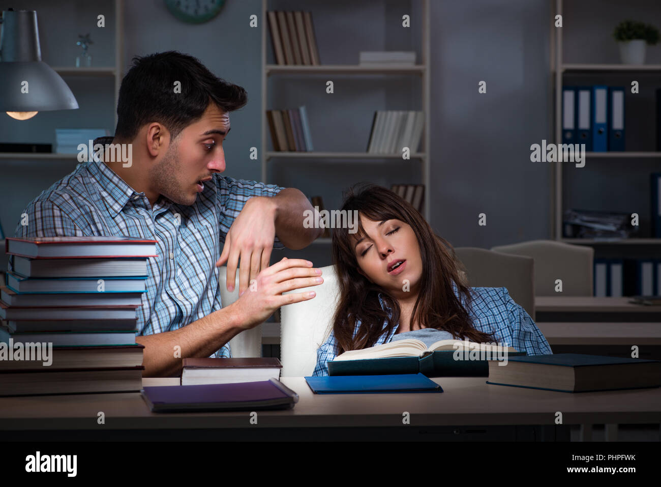 Two students studying late at night Stock Photo - Alamy