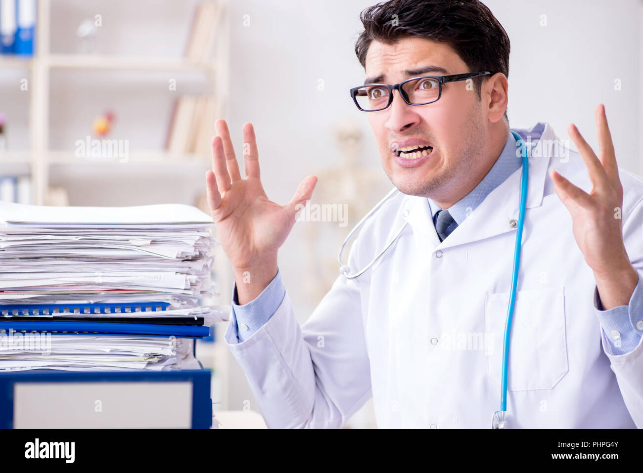 Busy doctor with too much work in hospital Stock Photo - Alamy