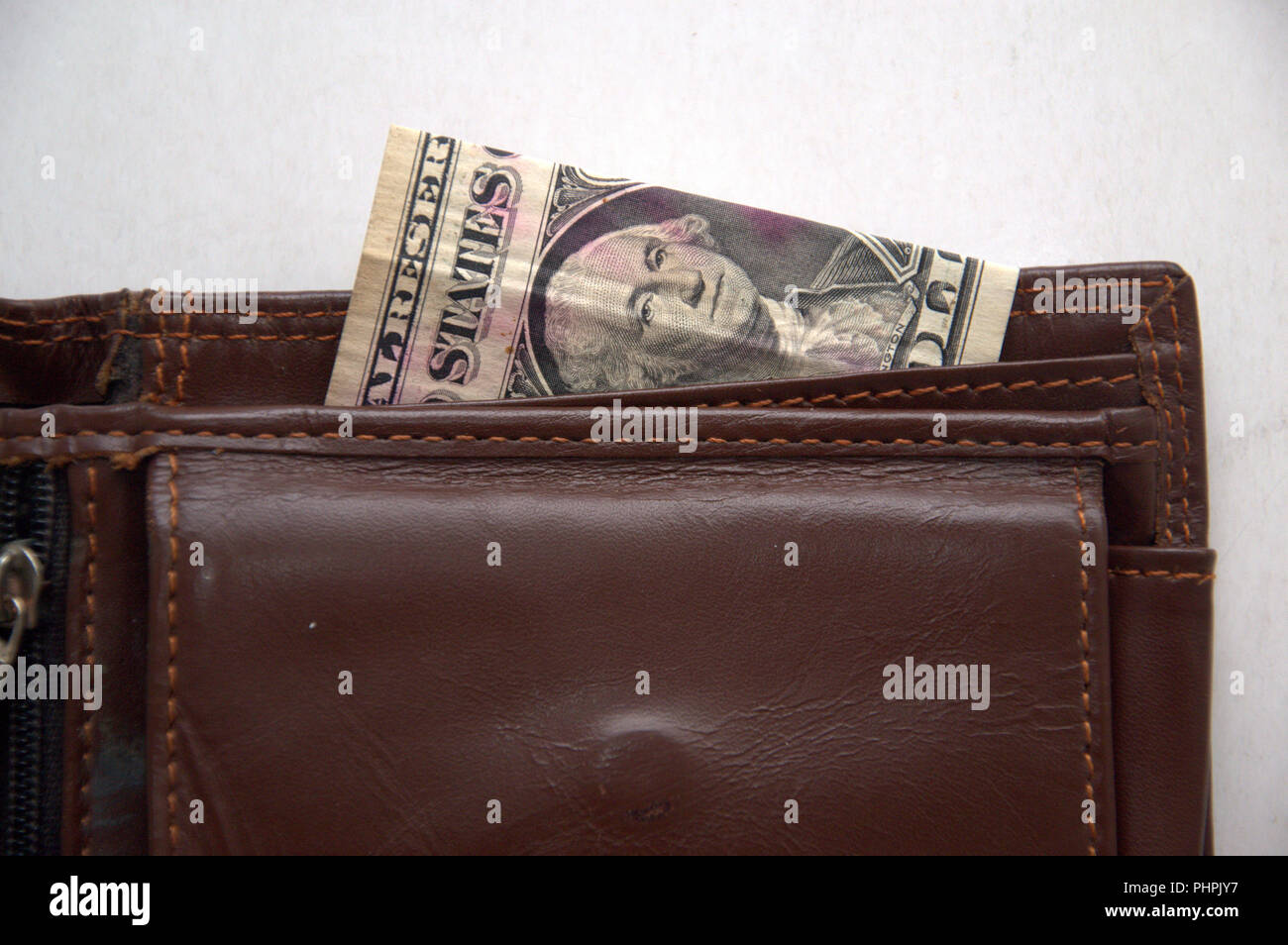 Man's wallet with one US dollar bill showing on white background Stock ...