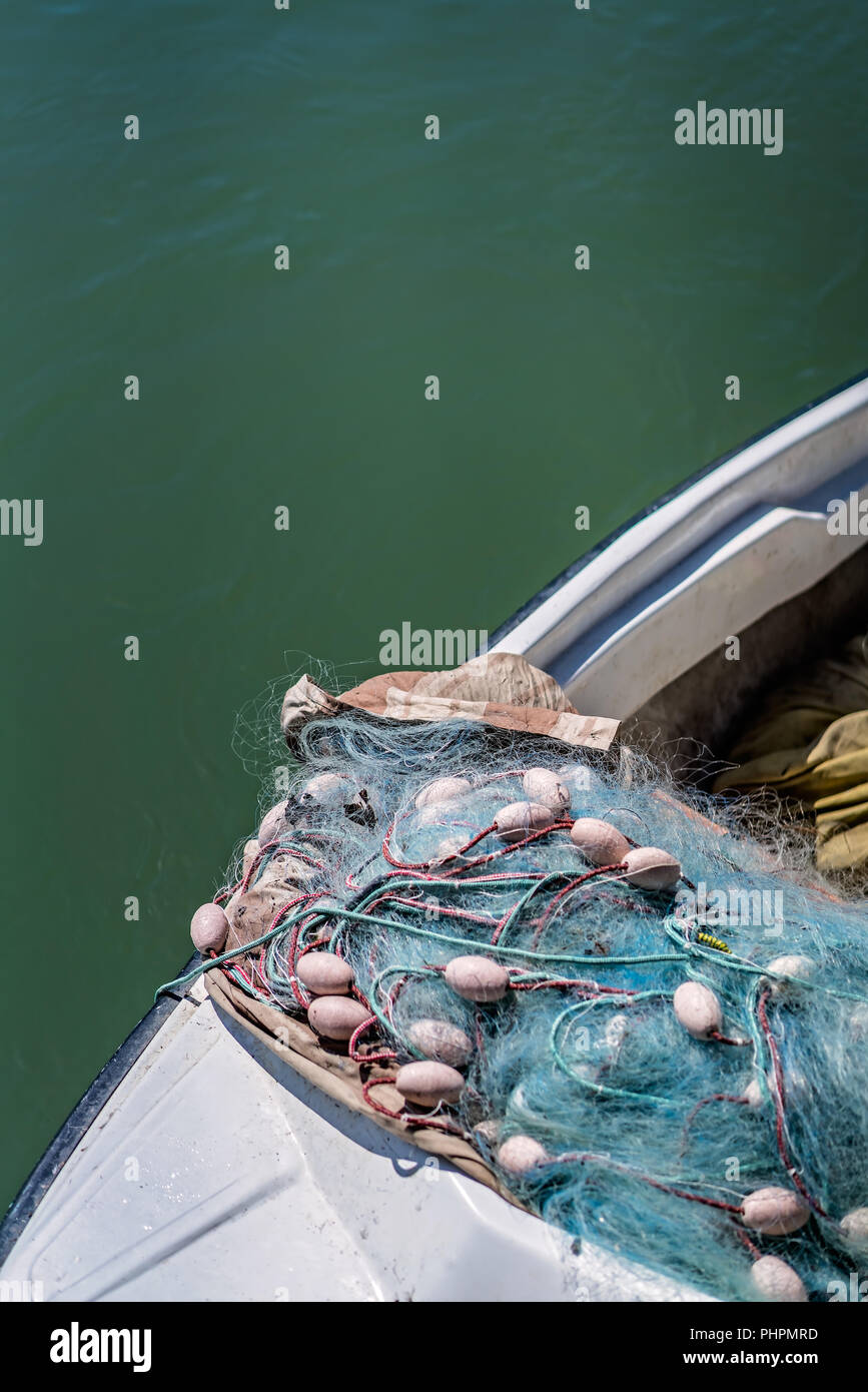 Fisherman boat and fishing net Stock Photo - Alamy