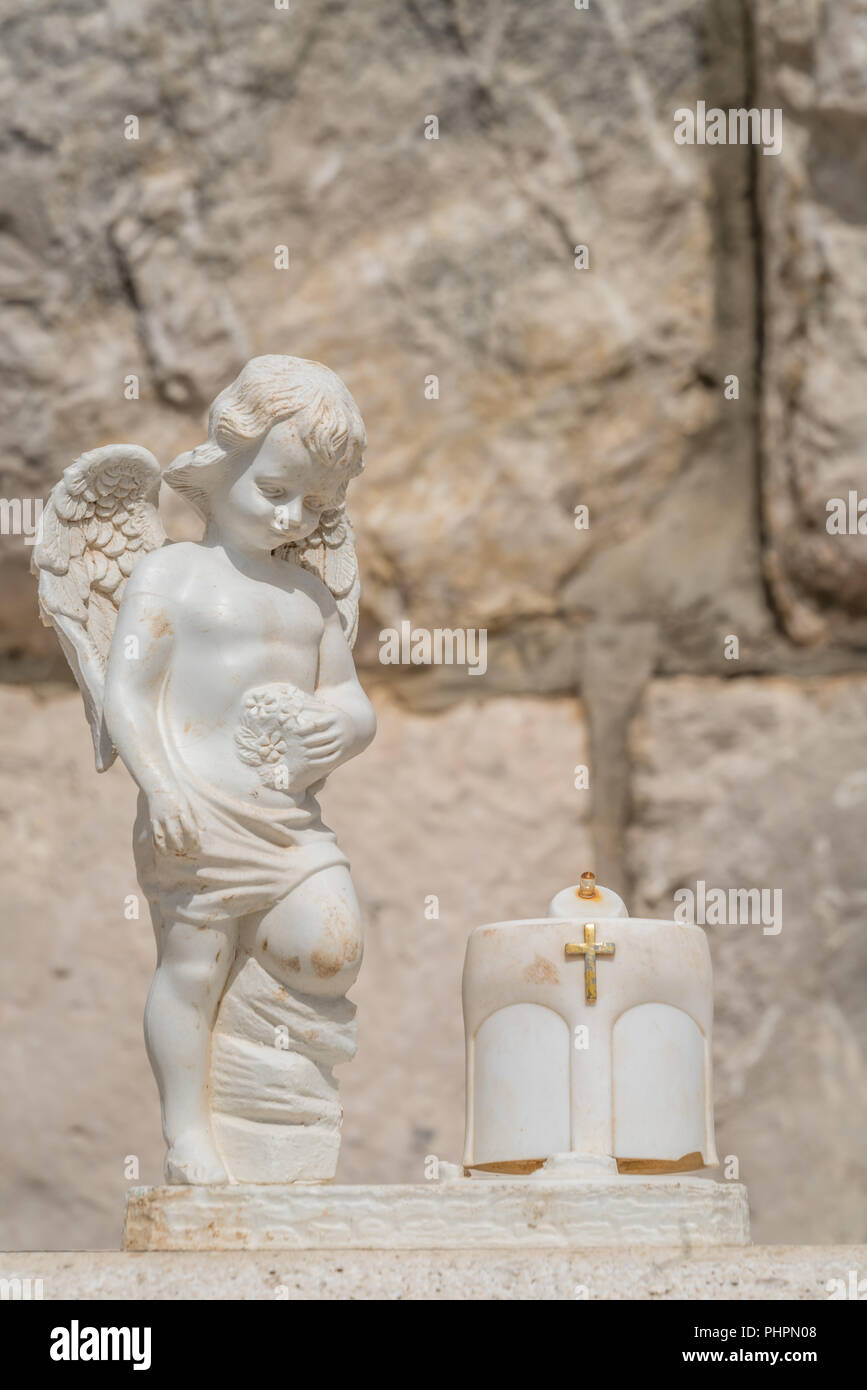Tiny white angel boy figure Stock Photo - Alamy