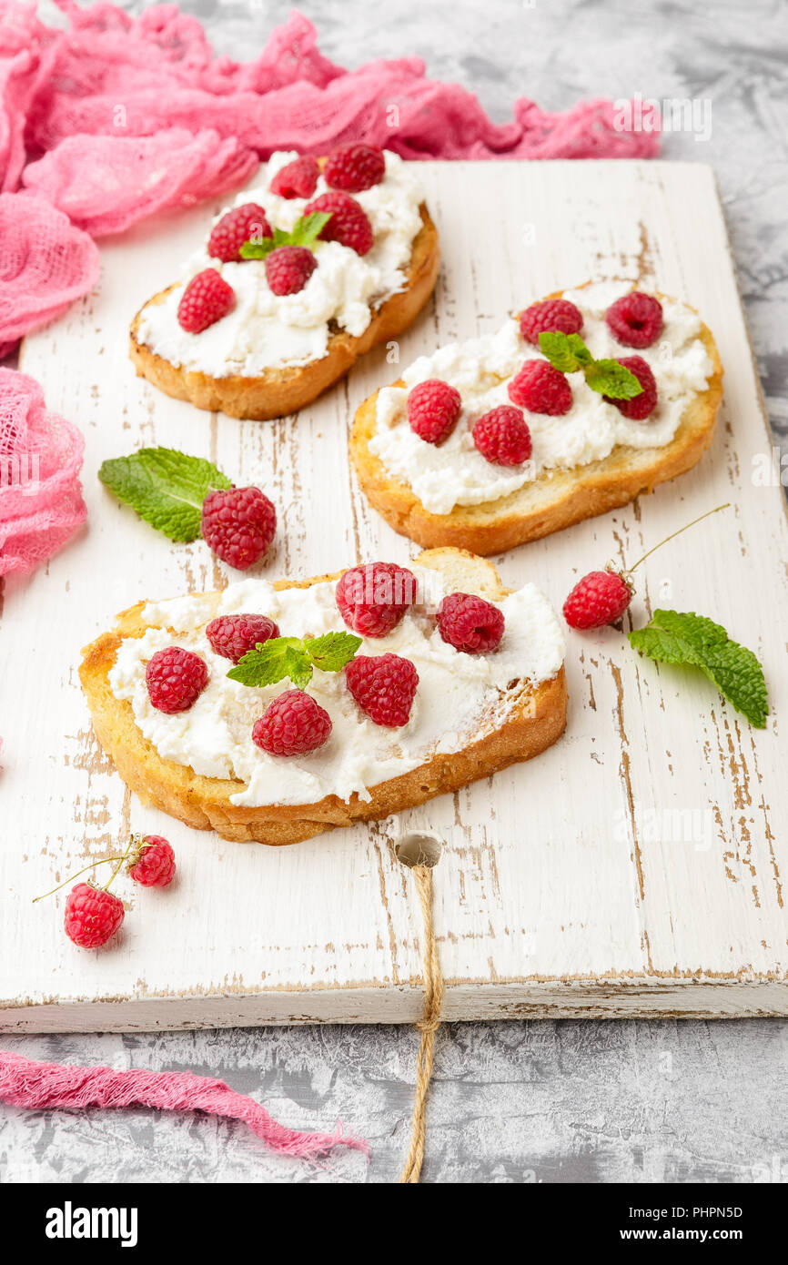 Breakfast slice of bread with Ricotta cheese served with raspberries ...