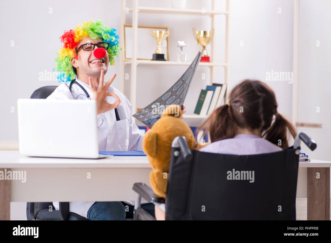 Funny pediatrician with little girl at regular check-up Stock Photo - Alamy