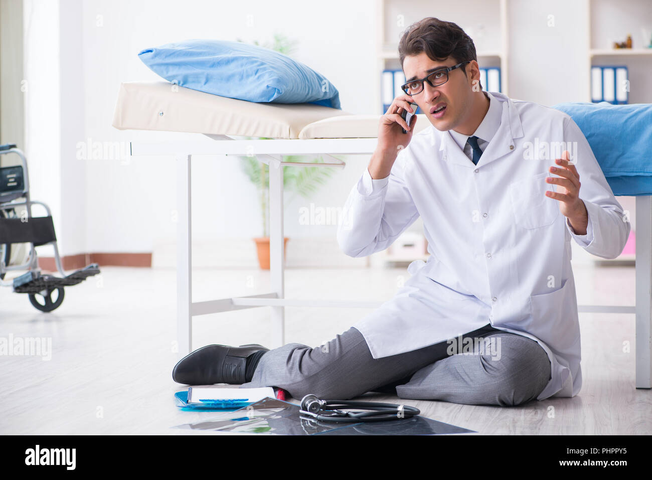 Doctor sitting on the floor in hospital Stock Photo - Alamy