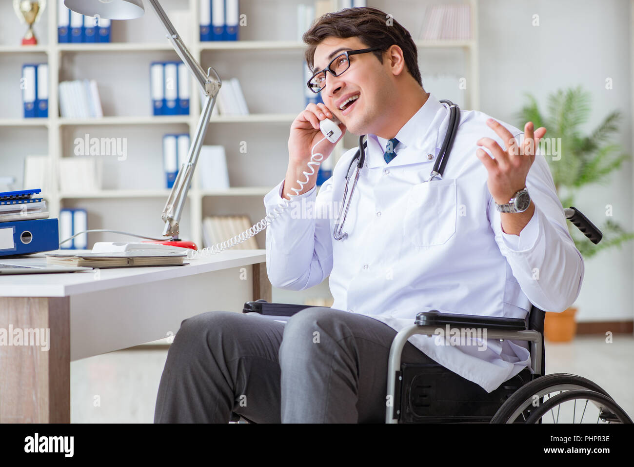 Disabled doctor on wheelchair working in hospital Stock Photo - Alamy