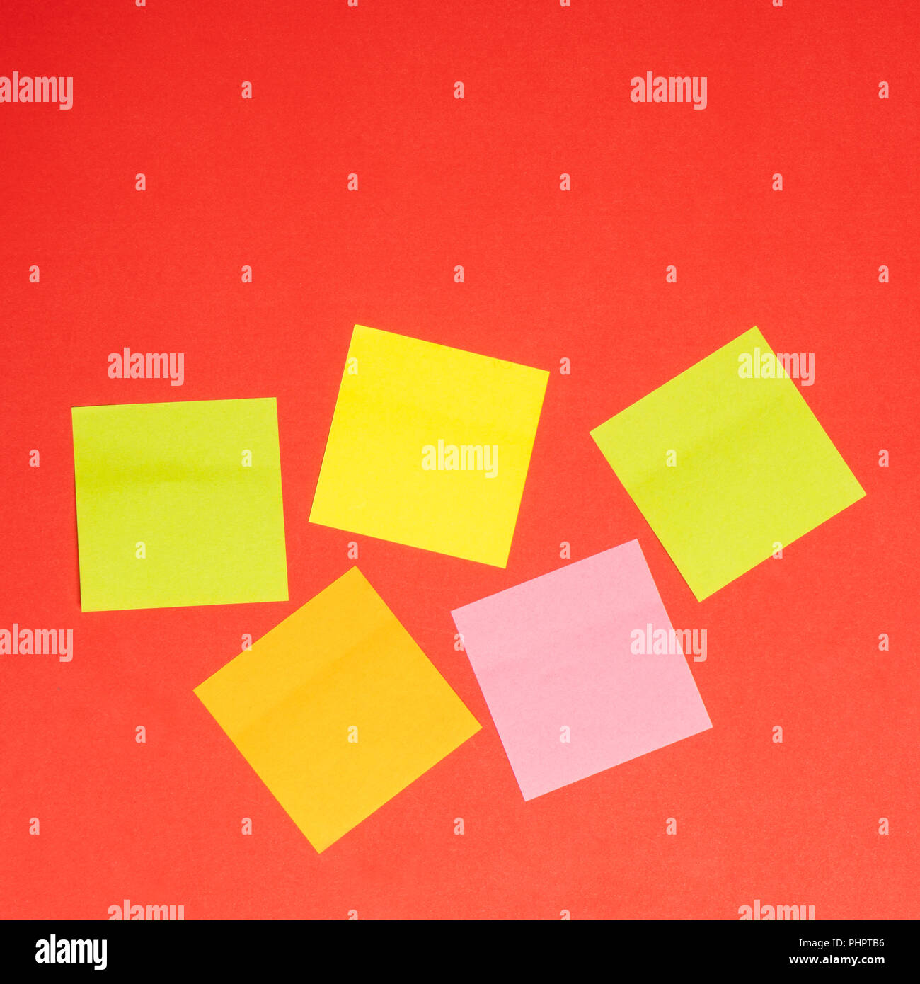 some colored notepad on a red background Stock Photo - Alamy