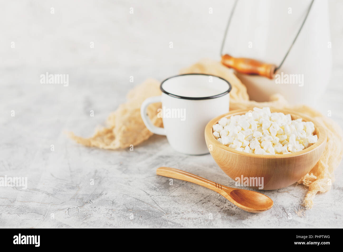 Granulated cottage cheese in wooden bowl and mug of milk Stock Photo ...