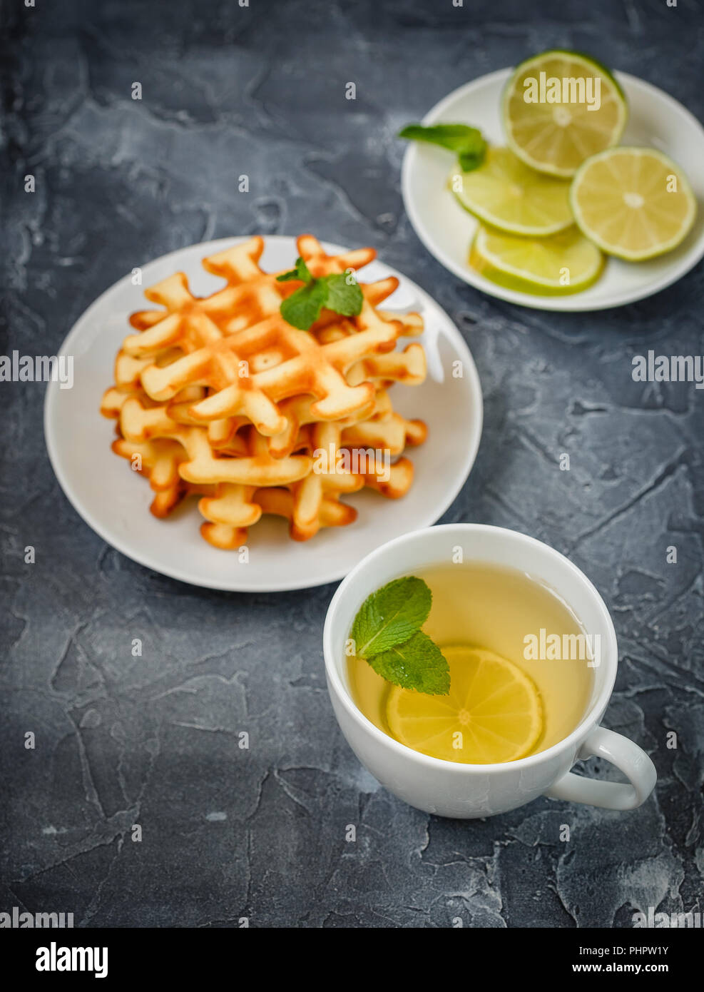 Belgian waffles and green Tea Stock Photo - Alamy