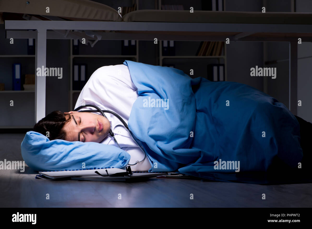 Doctor working night shift in hospital after long hours Stock Photo - Alamy