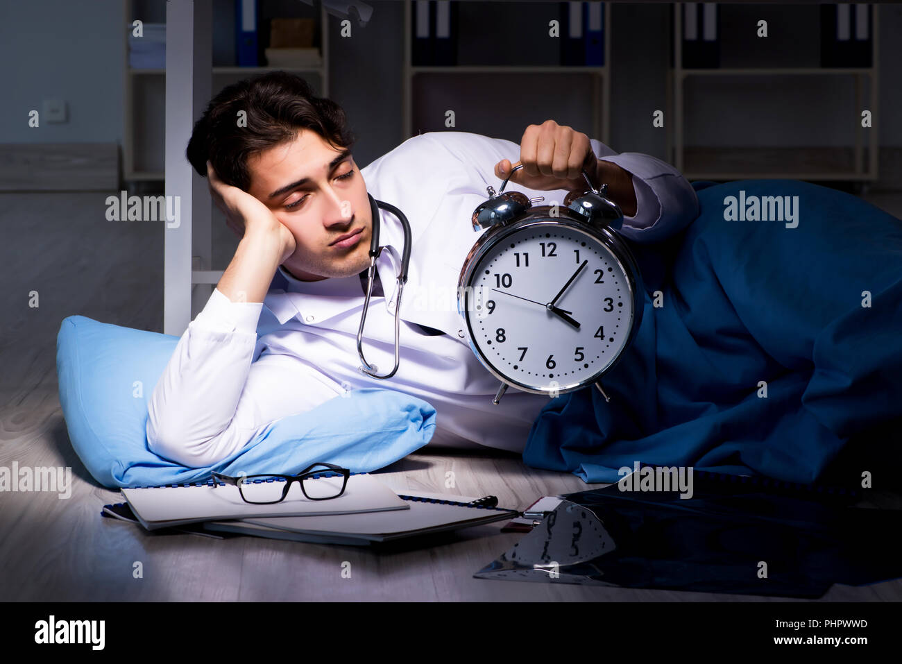 Doctor working night shift in hospital after long hours Stock Photo - Alamy