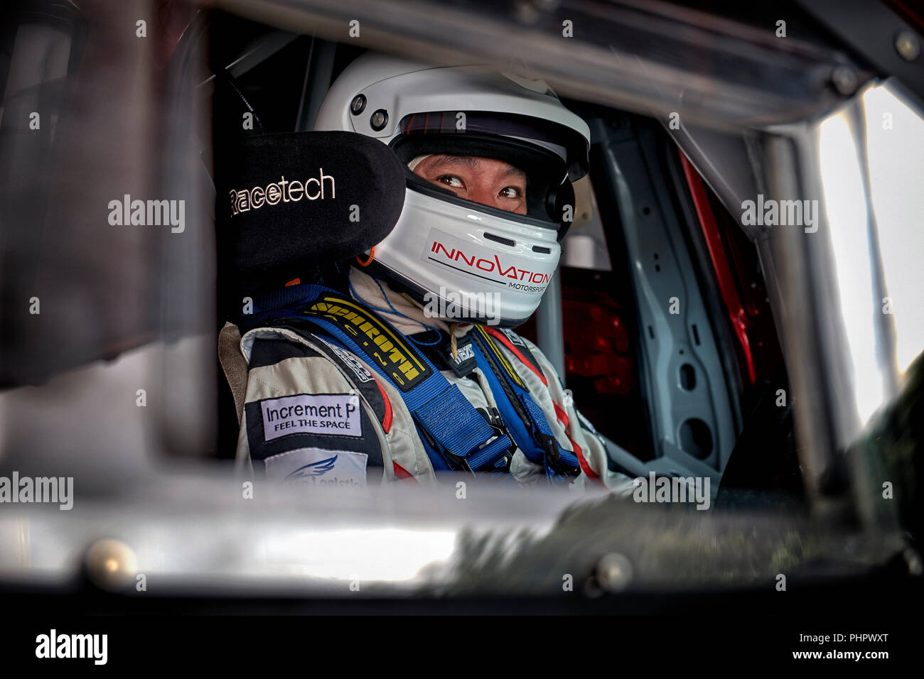Racing car driver. Through the window view of a driver behind the wheel ...
