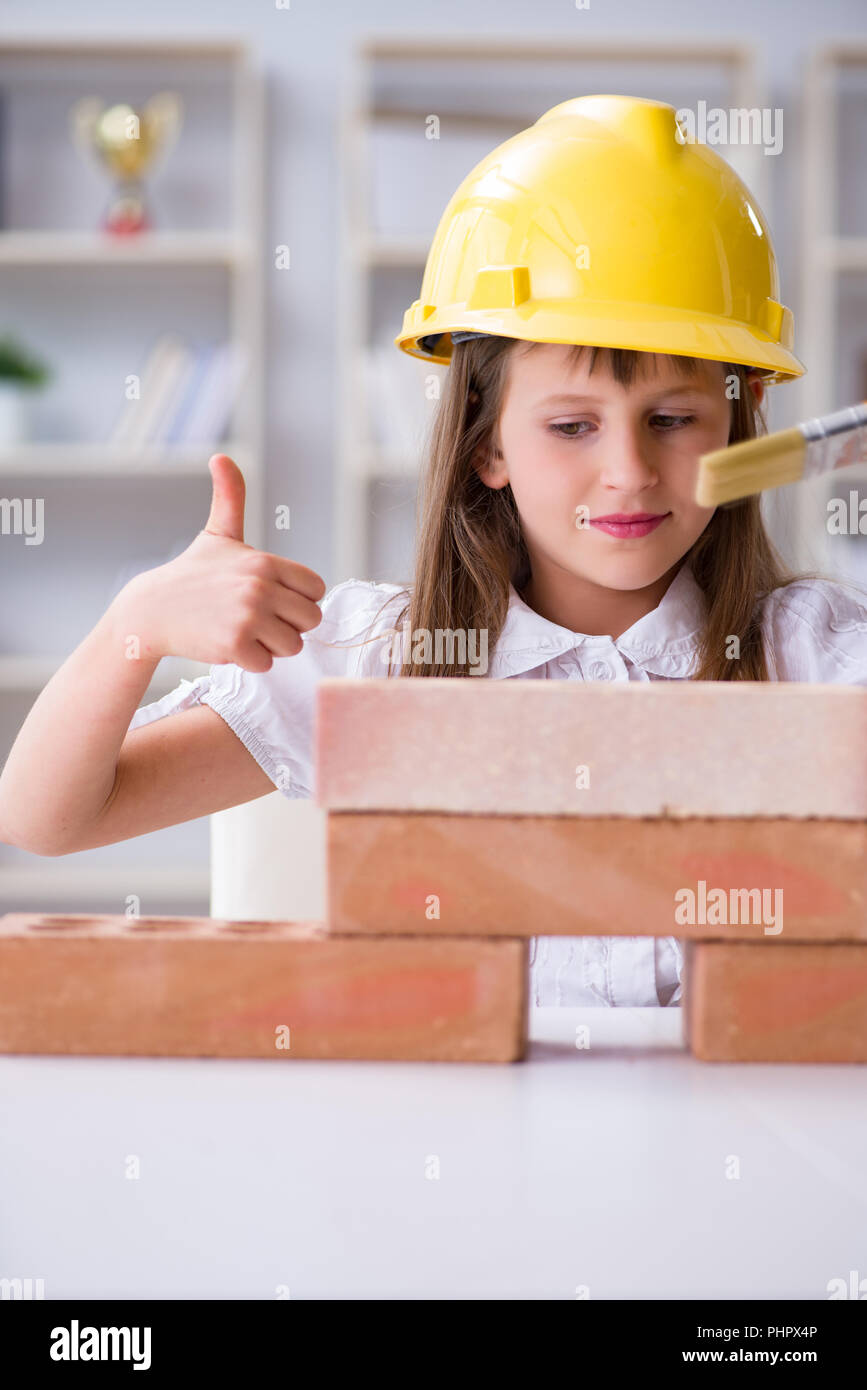 Young girl building with construction bricks Stock Photo - Alamy