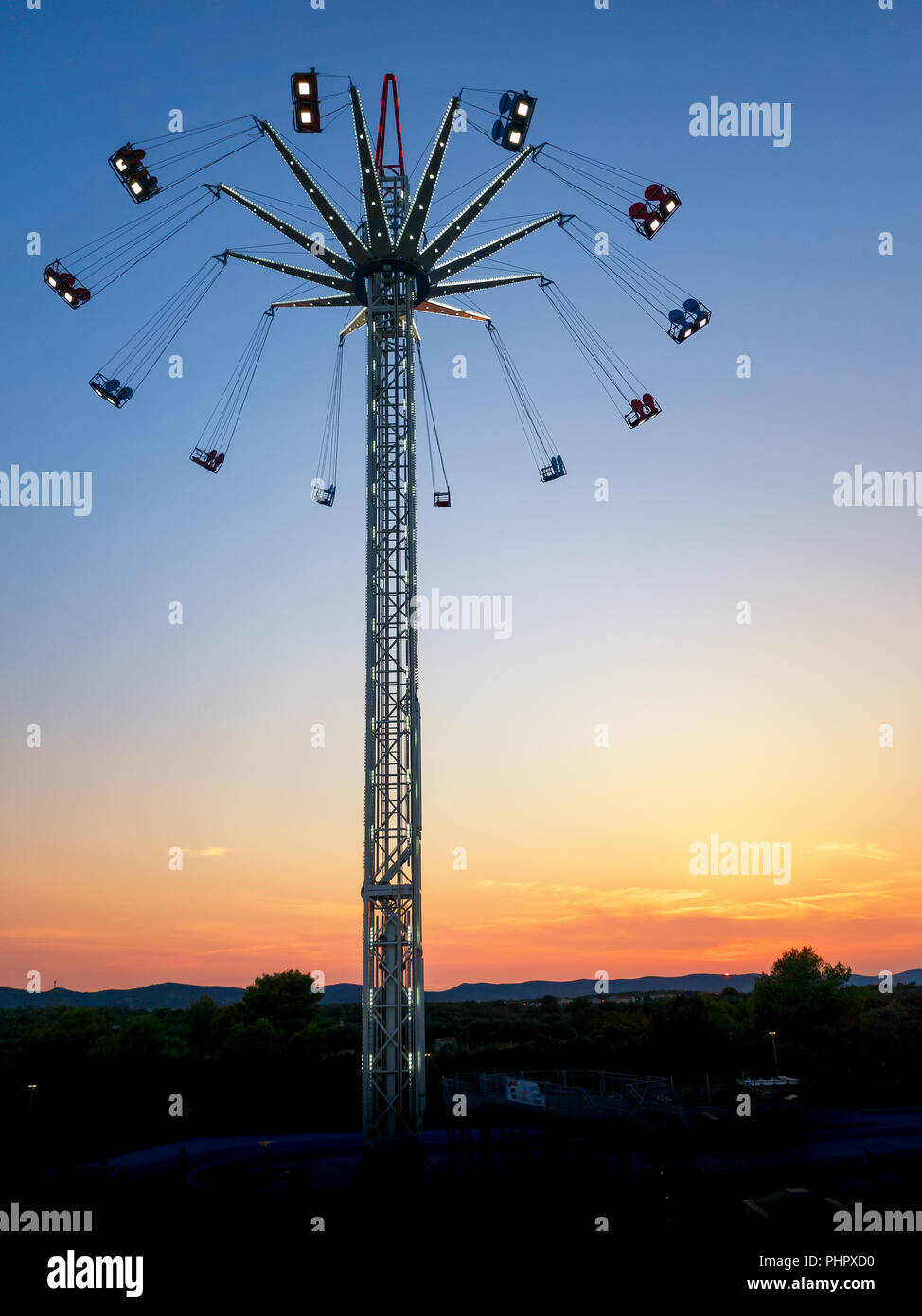 Swing ride. Star flyer. Amusement ride in sunset Stock Photo - Alamy