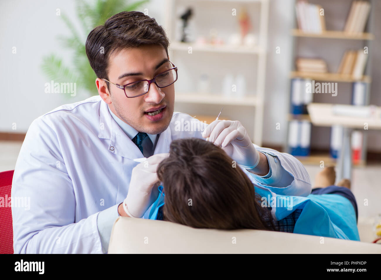 Patient visiting dentist for regular check-up and filling Stock Photo ...