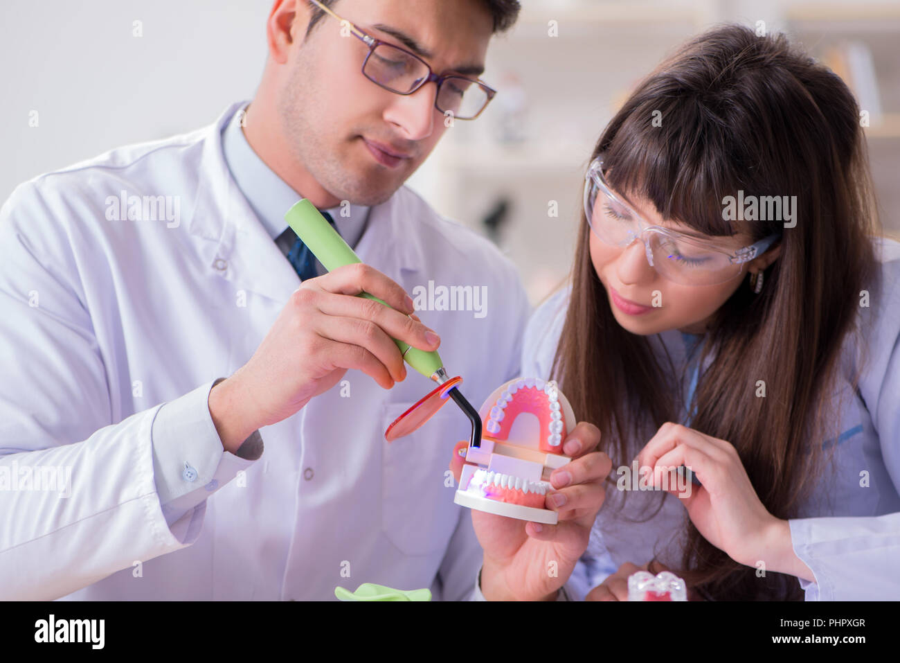 Doctor explaining to assistant how to use ultraviolet gun Stock Photo ...