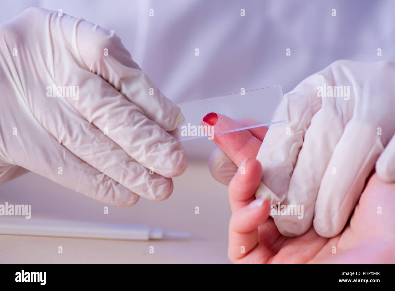 Doctor taking blood samples from finger Stock Photo - Alamy