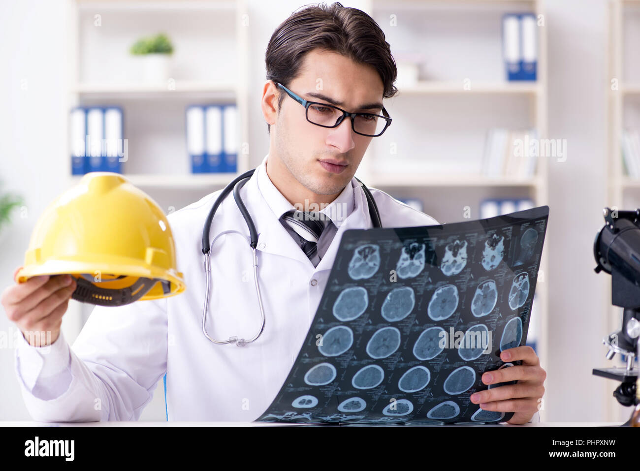Safety doctor advising about wearing hard hat Stock Photo - Alamy