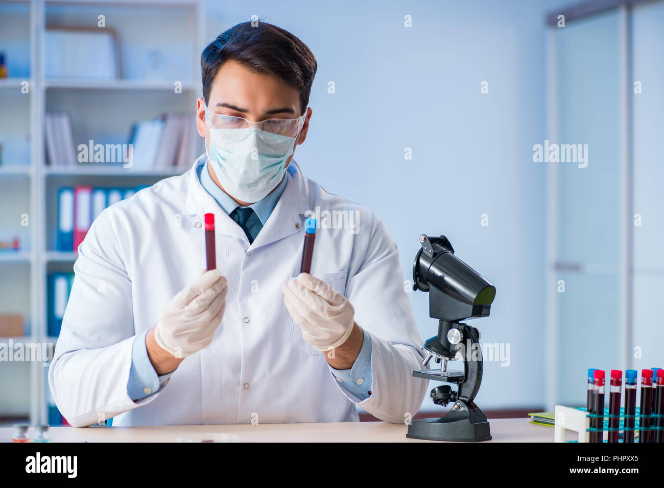 Lab assistant testing blood samples in hospital Stock Photo - Alamy