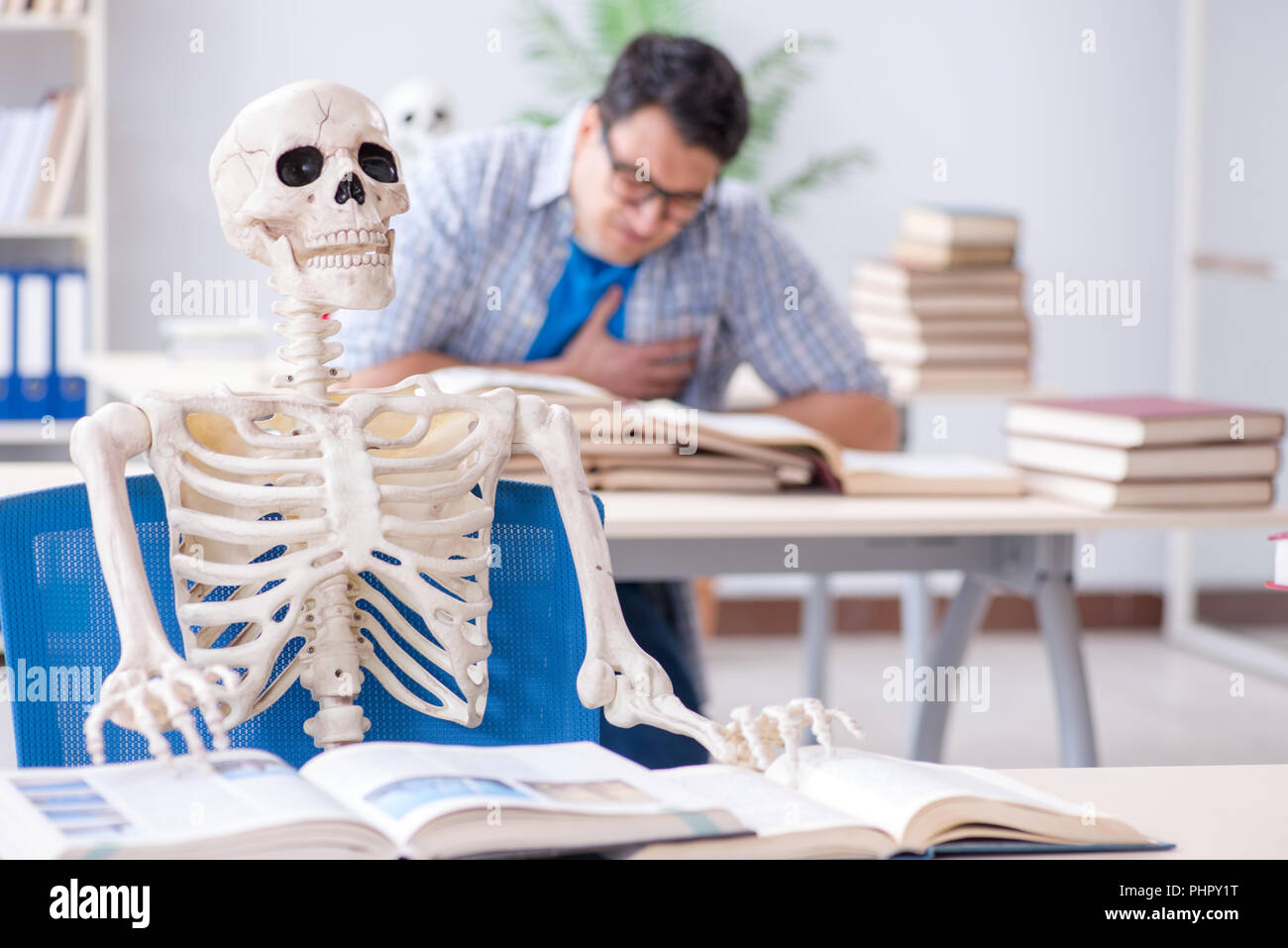 Student skeleton listening to lecture in classroom Stock Photo - Alamy