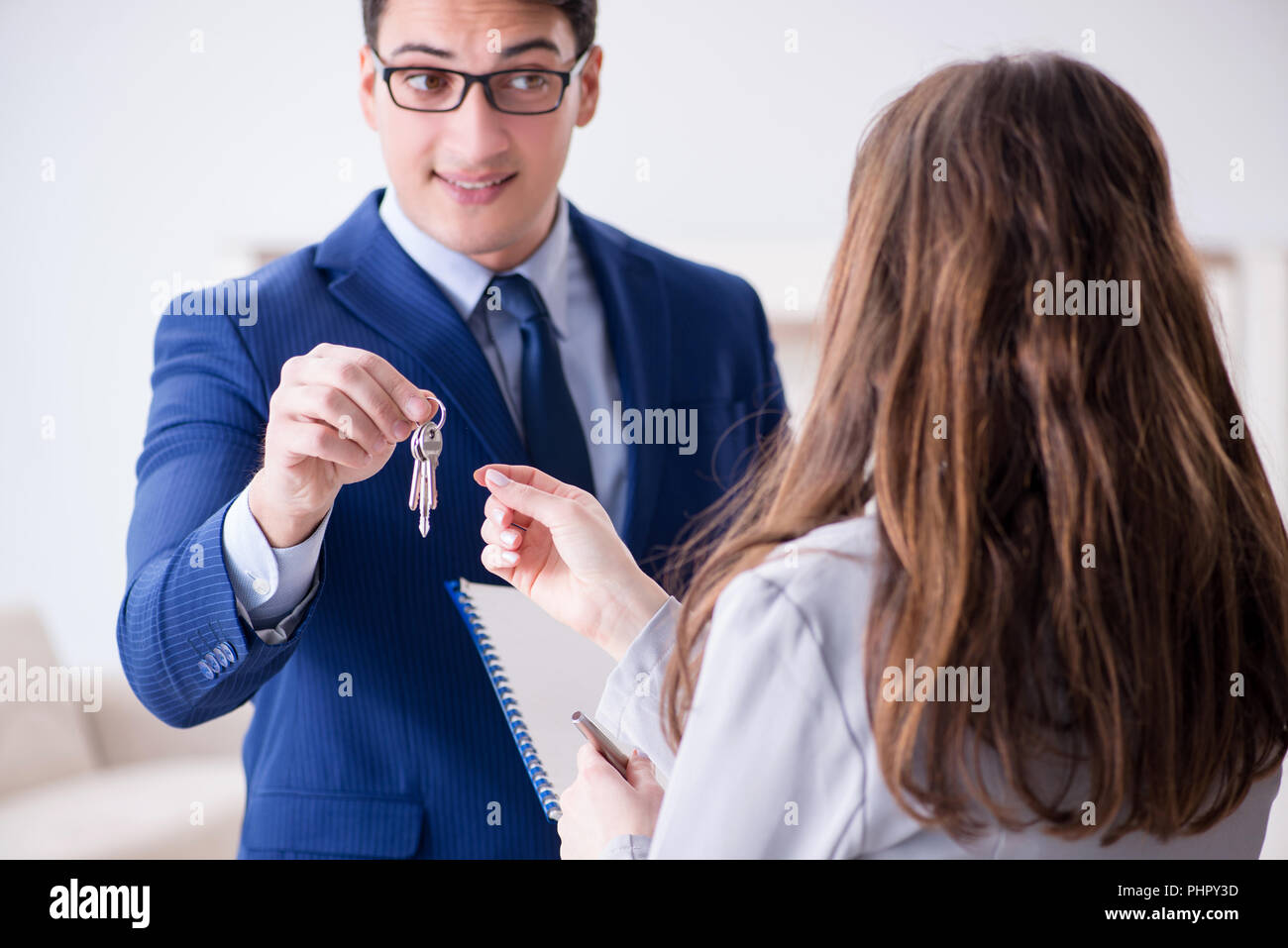 Real estate agent showing new apartment to owner Stock Photo - Alamy