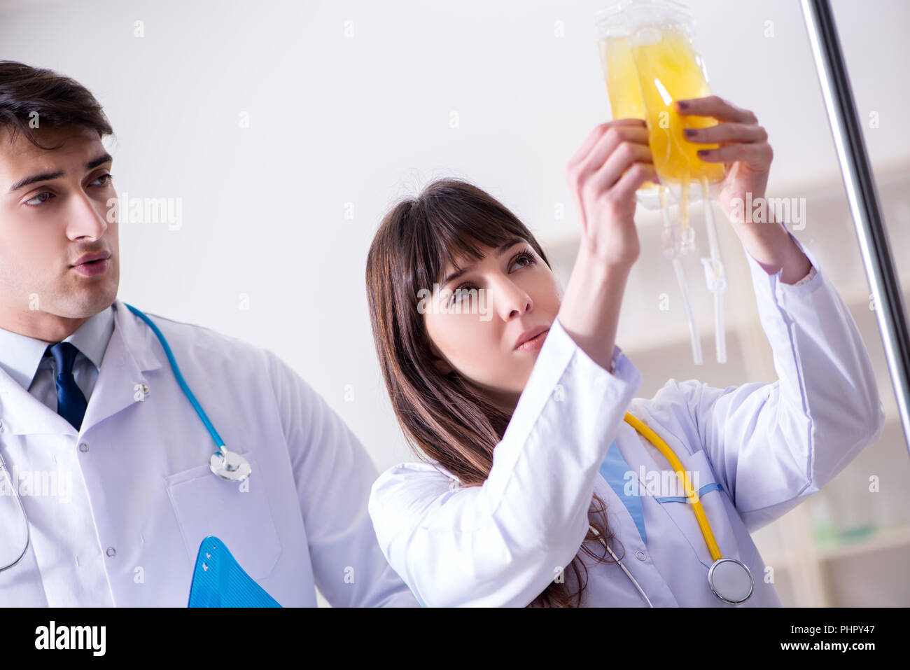 Two doctors discussing plasma and blood transfusion Stock Photo - Alamy