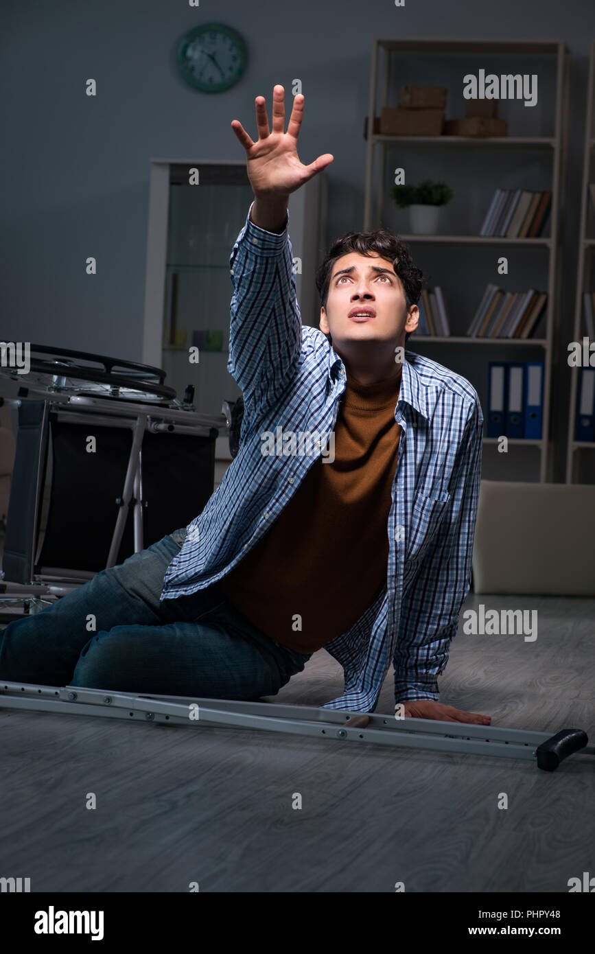 Man fell off wheelchair sitting on the floor Stock Photo - Alamy