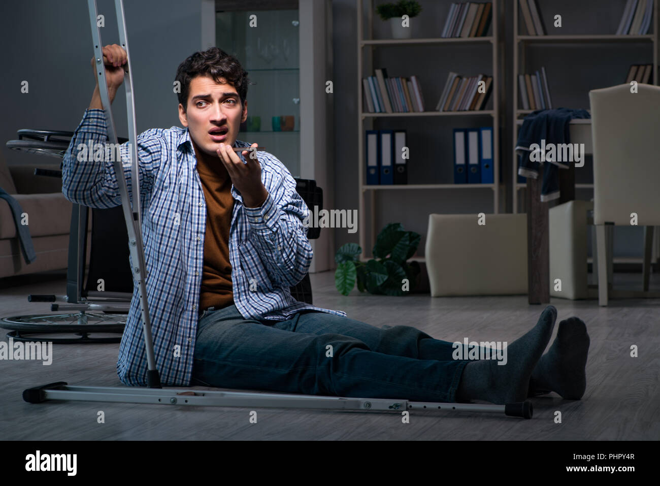 Man fell off wheelchair sitting on the floor Stock Photo - Alamy