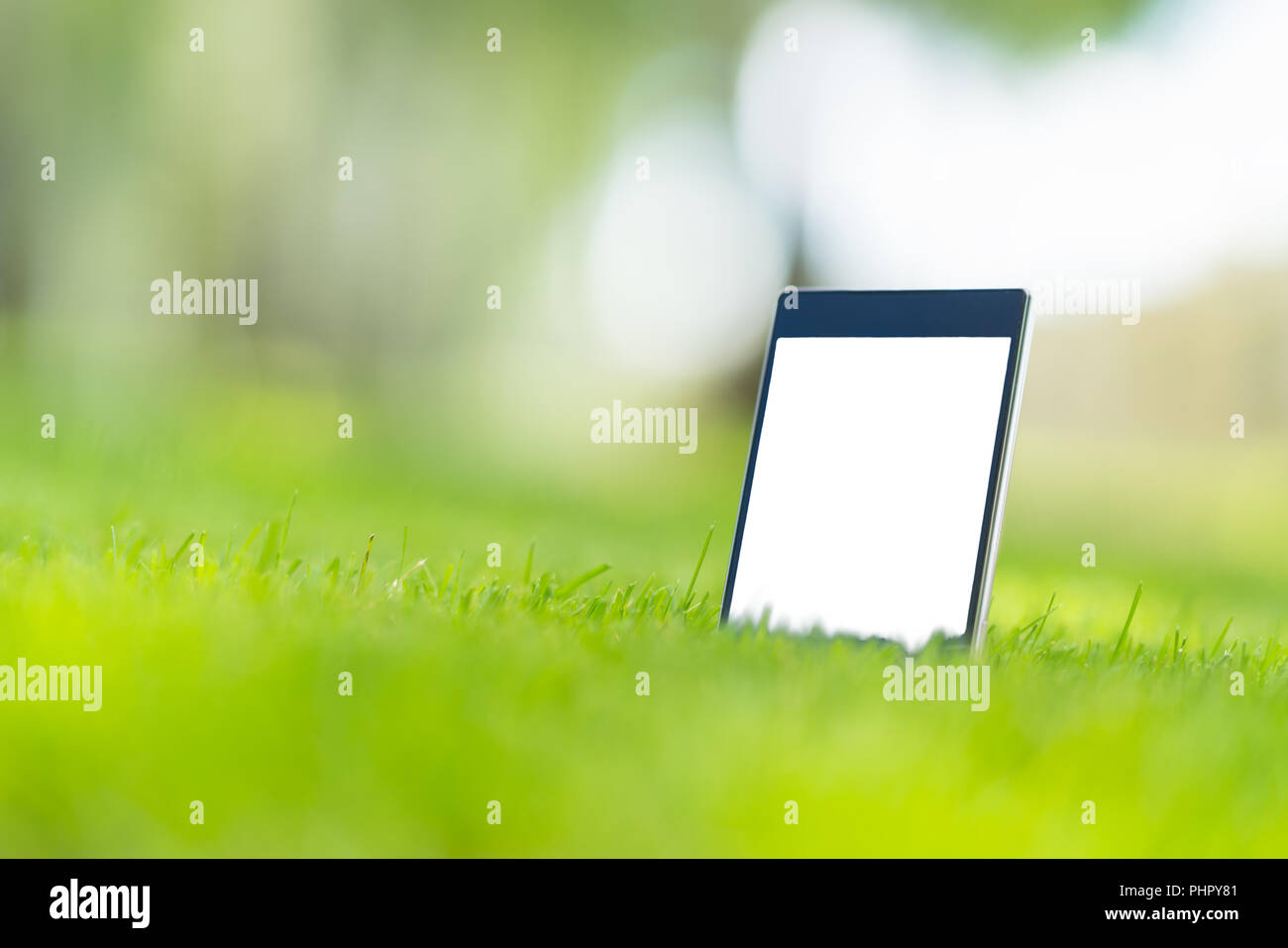 Tablet computer with a blank white screen and copy space standing ...