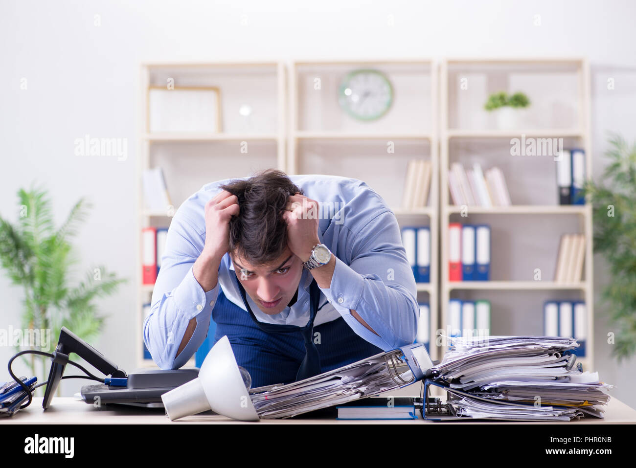 Angry businessman frustrated with too much work Stock Photo - Alamy