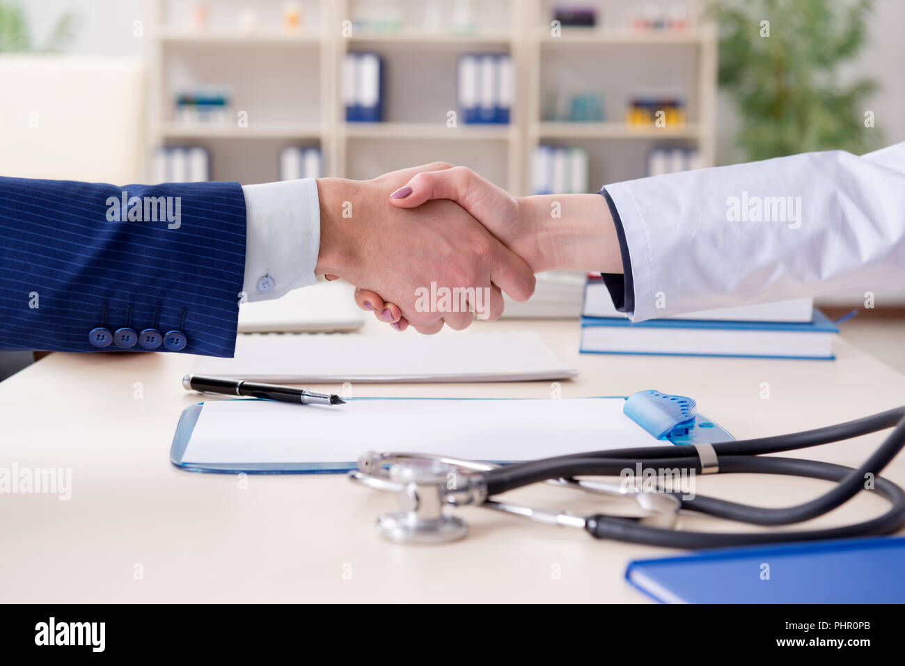 Man signing medical insurance contract Stock Photo - Alamy