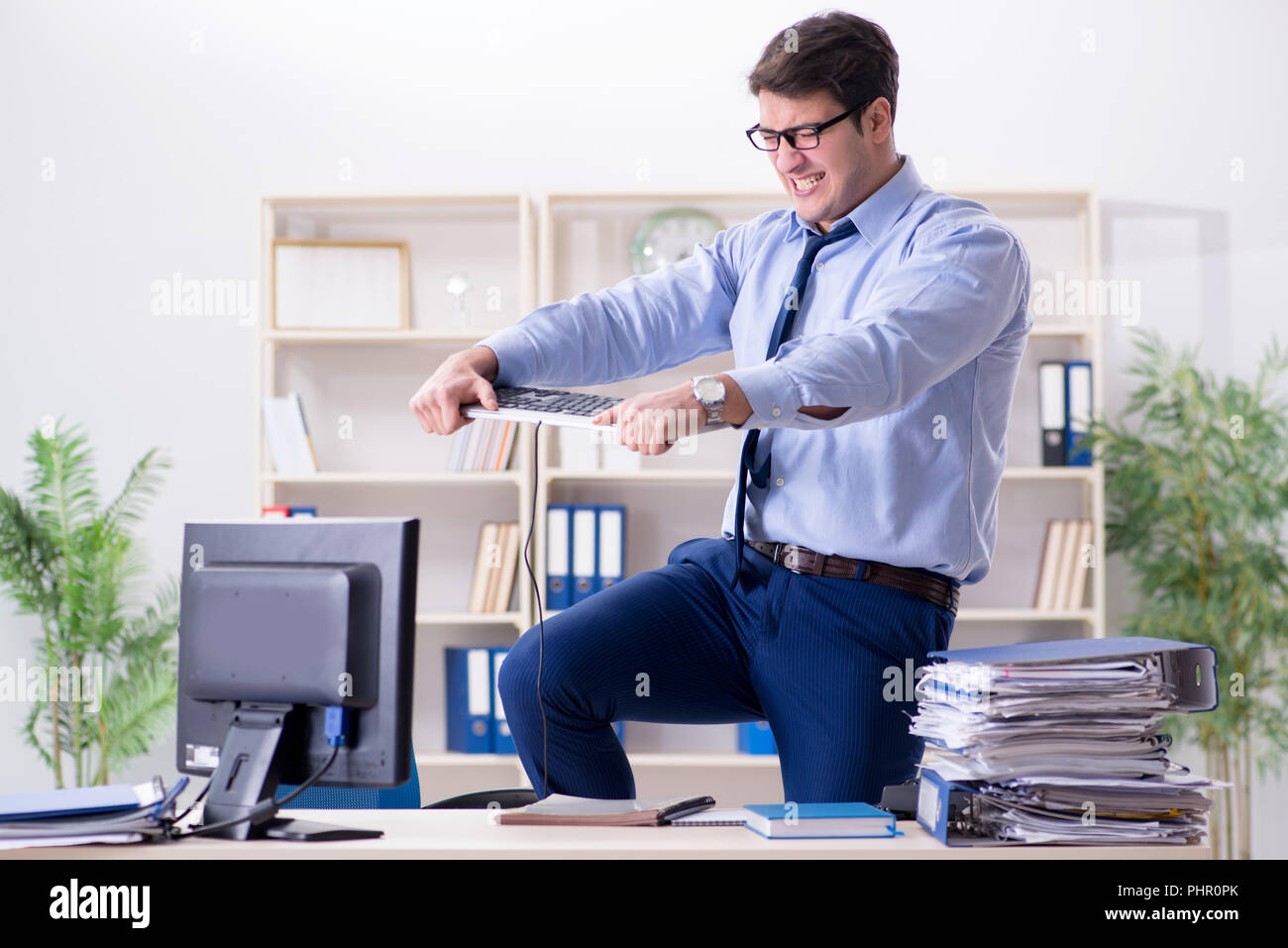 Angry businessman frustrated with too much work Stock Photo - Alamy