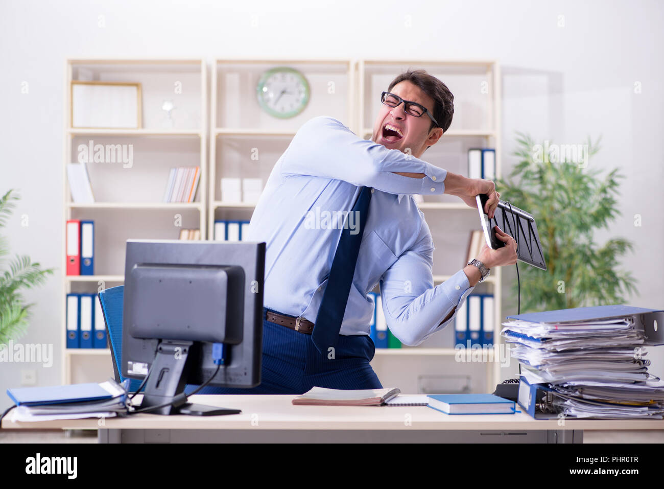 Angry businessman frustrated with too much work Stock Photo - Alamy