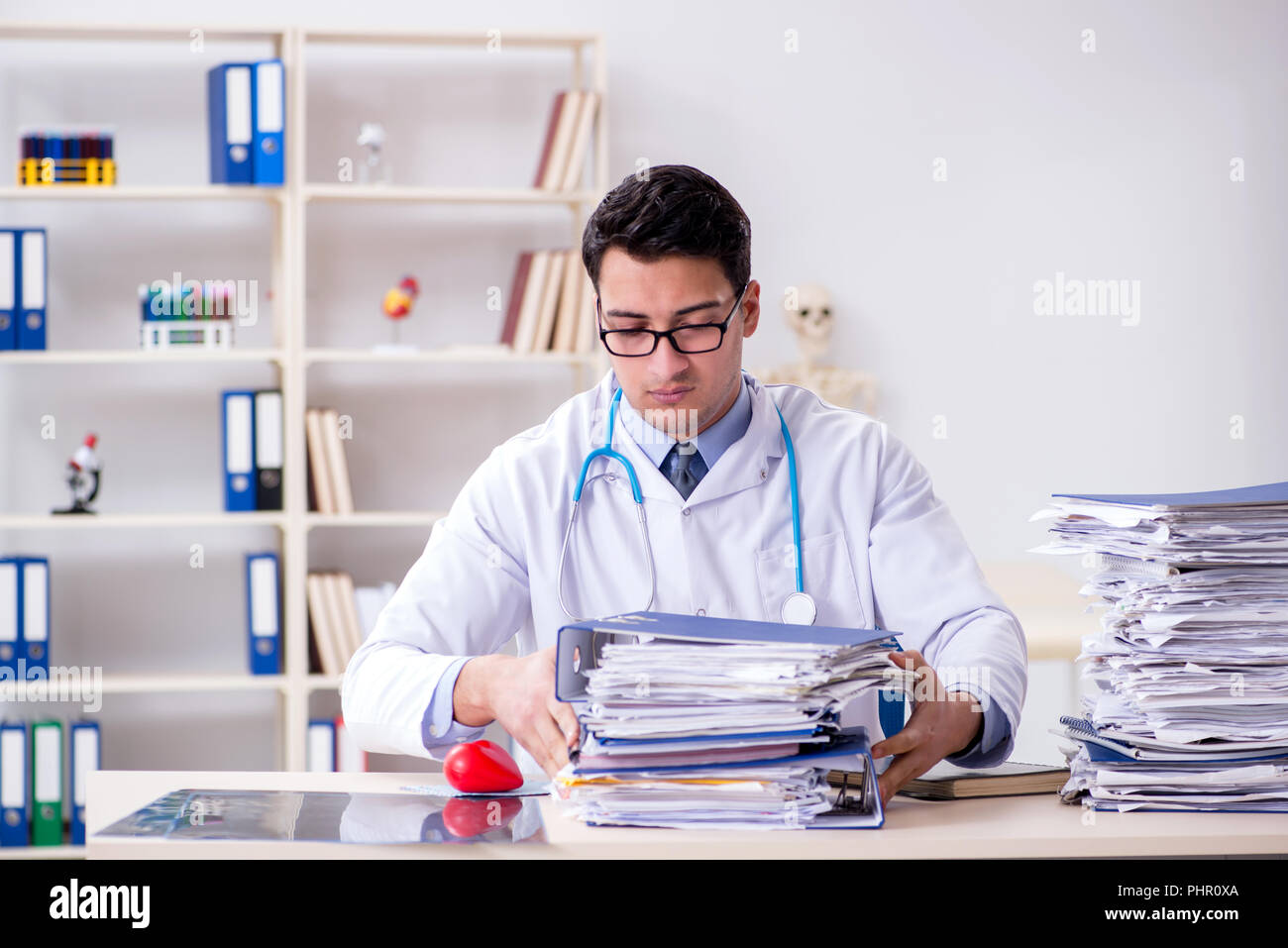 Busy doctor with too much work in hospital Stock Photo - Alamy