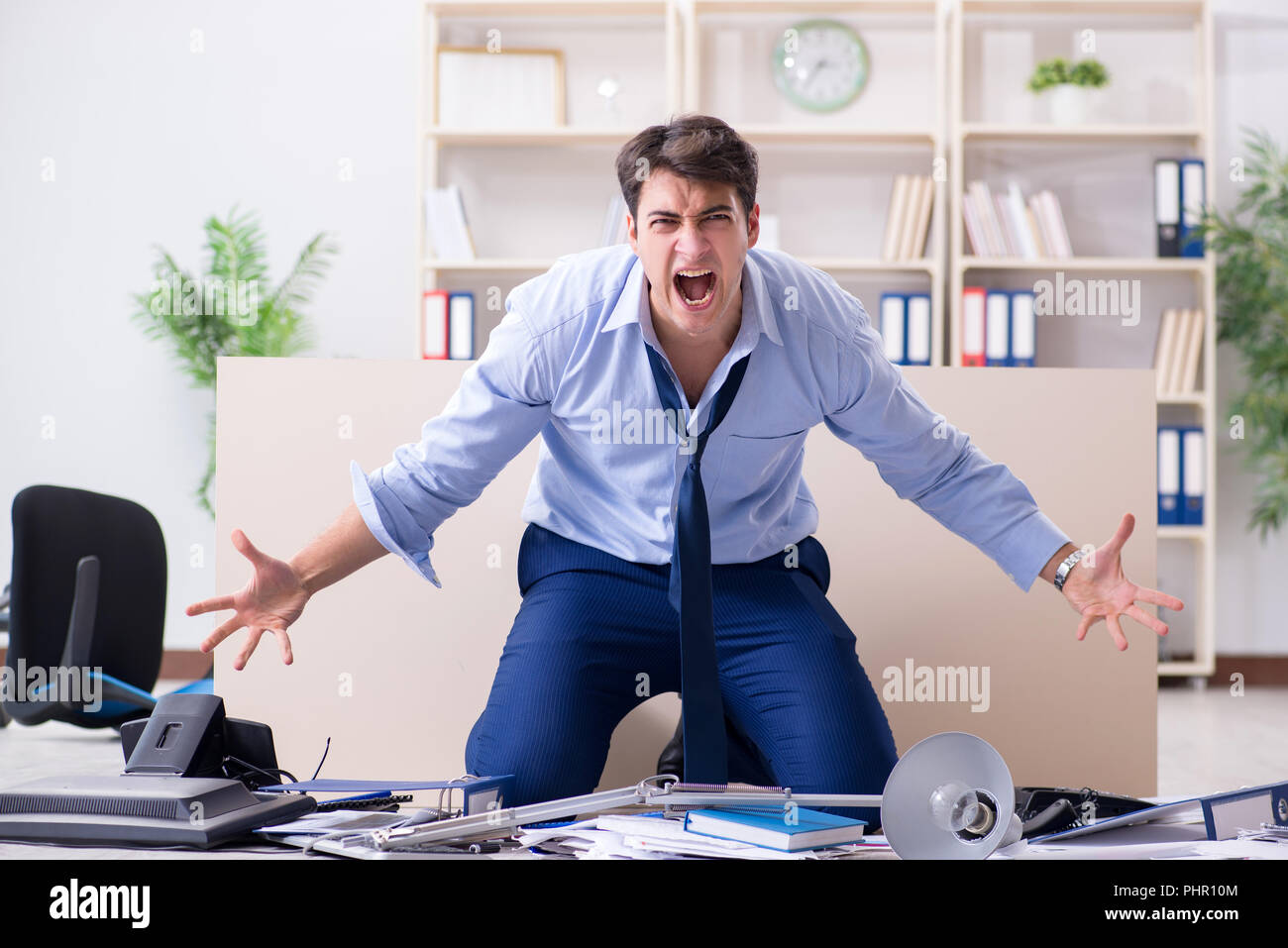 Angry businessman frustrated with too much work Stock Photo - Alamy