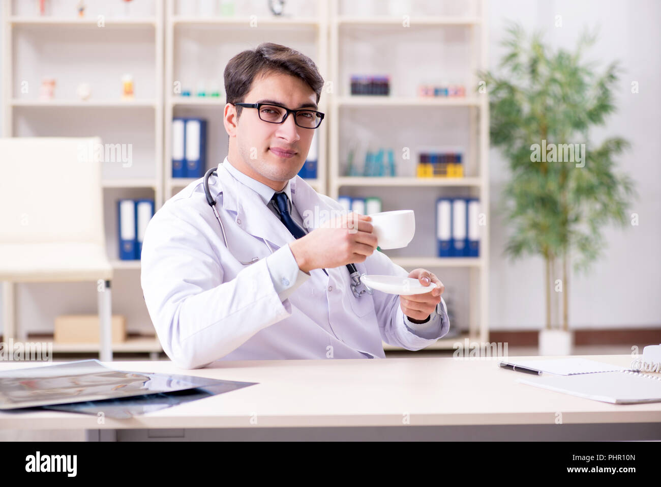 Young doctor drinking coffee in hi-res stock photography and images - Alamy