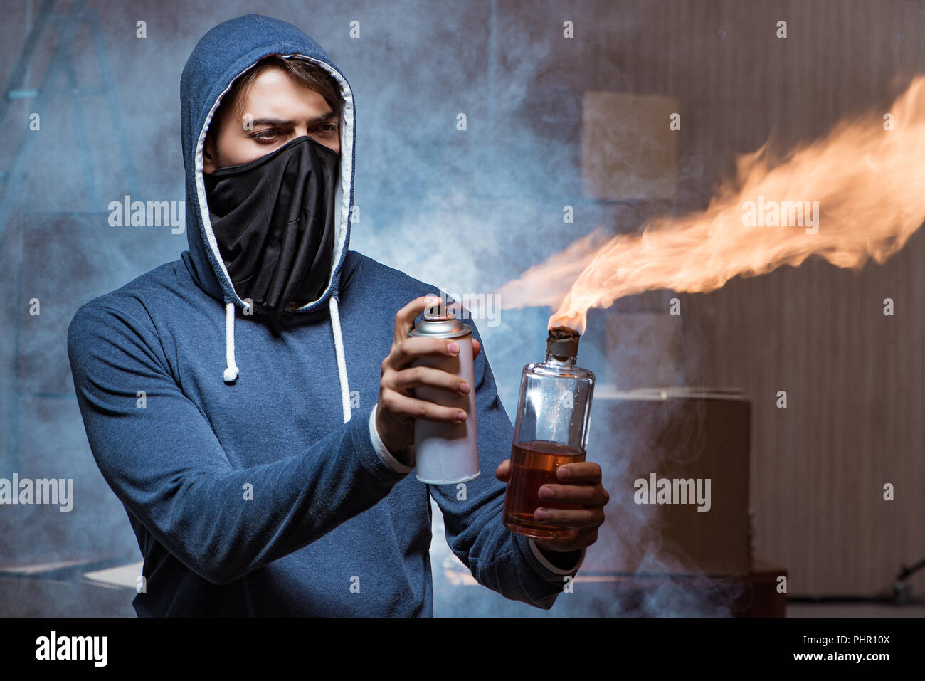 Rebel with molotov cocktail in dark room Stock Photo - Alamy