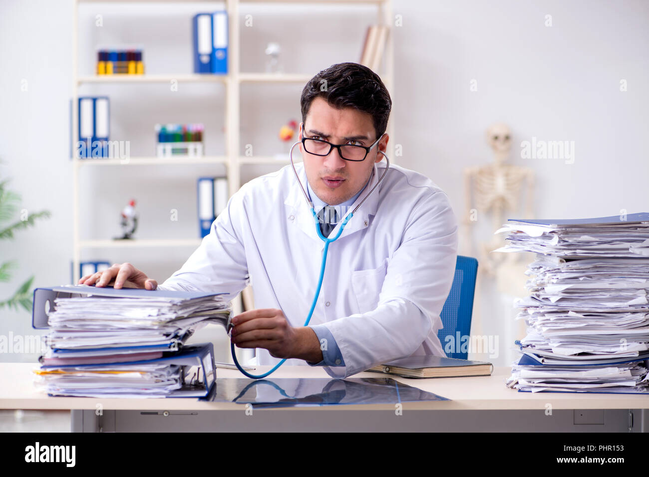 Busy doctor with too much work in hospital Stock Photo - Alamy