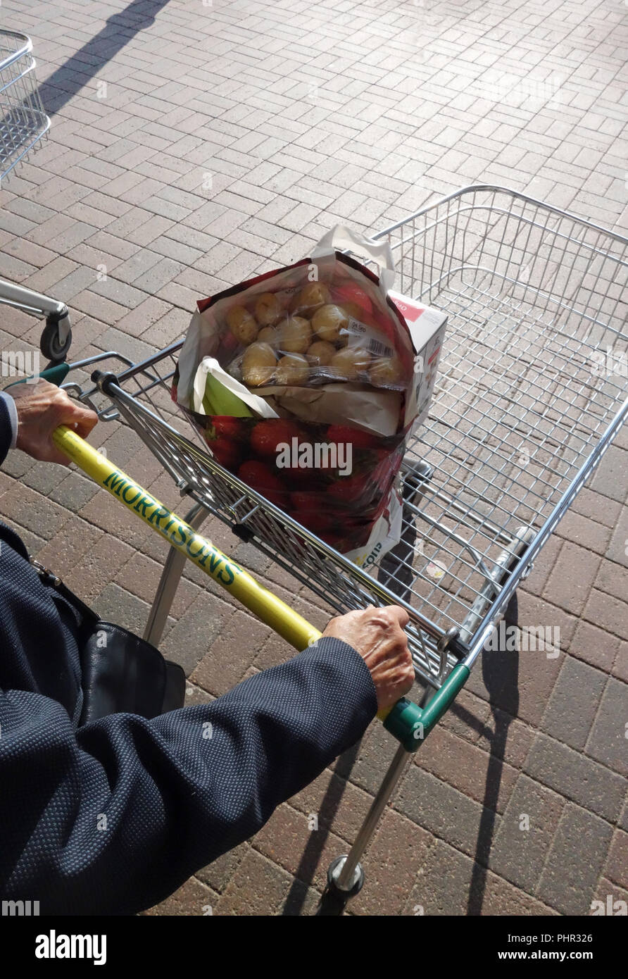 Elderly lady supermarket shopping at Morrisons, Halfway, Sheffield ...