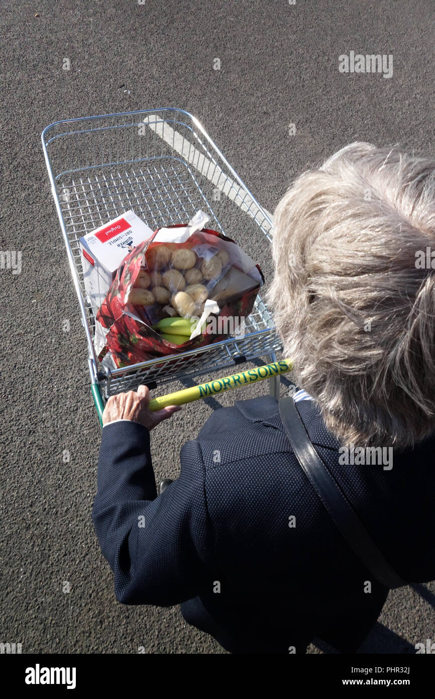 Elderly lady supermarket shopping at Morrisons, Halfway, Sheffield ...