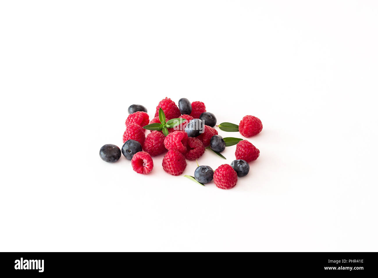 Blueberries and raspberries on white background Stock Photo - Alamy