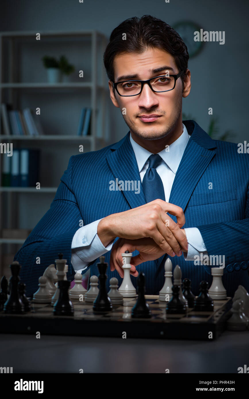 Businessman playing chess in strategy concept Stock Photo - Alamy