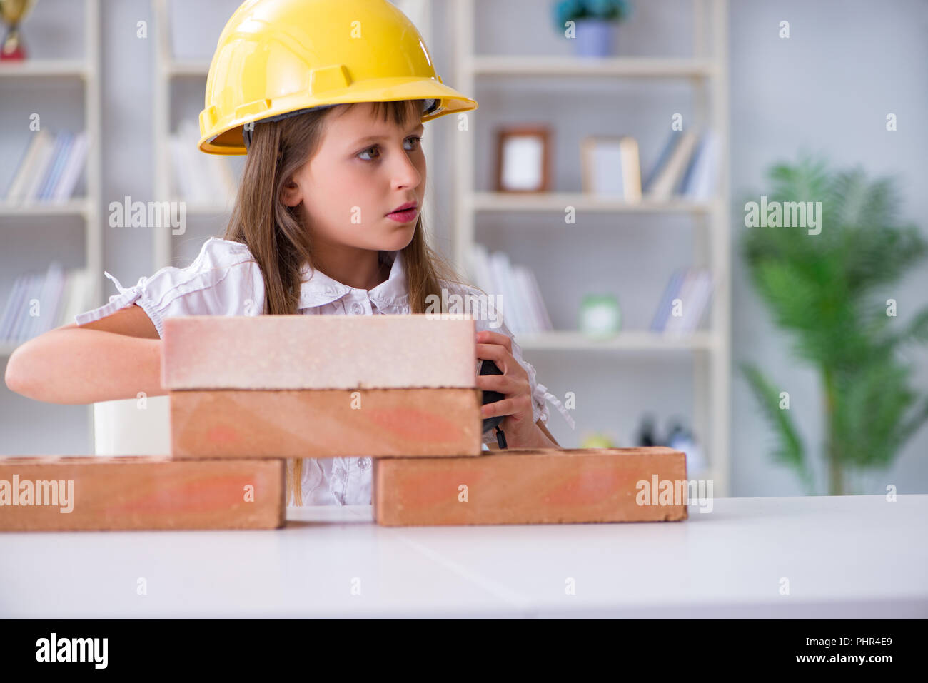 Young girl building with construction bricks Stock Photo - Alamy